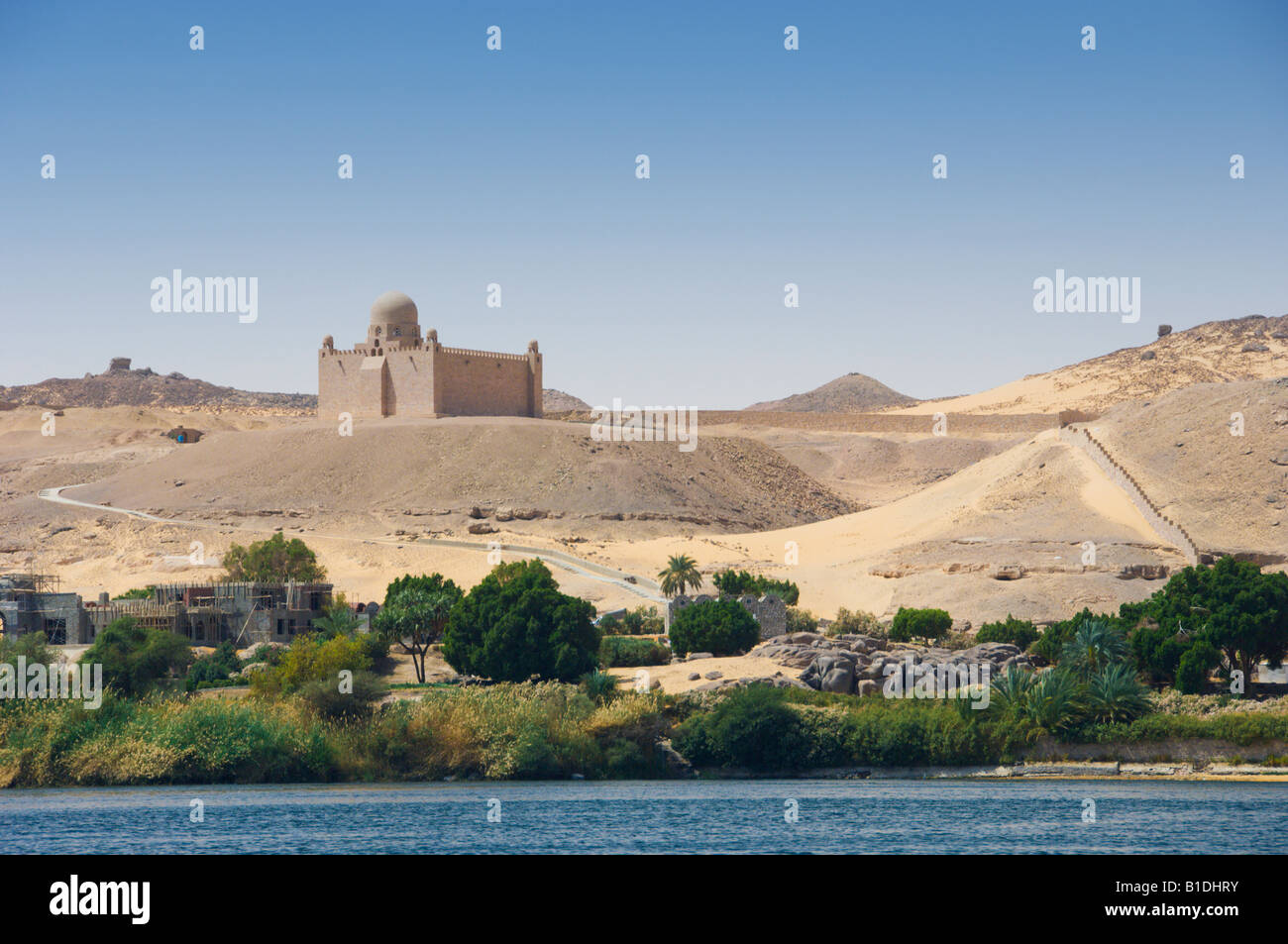An islamic mosque on a hill across the Nile river from Aswan Egypt ...