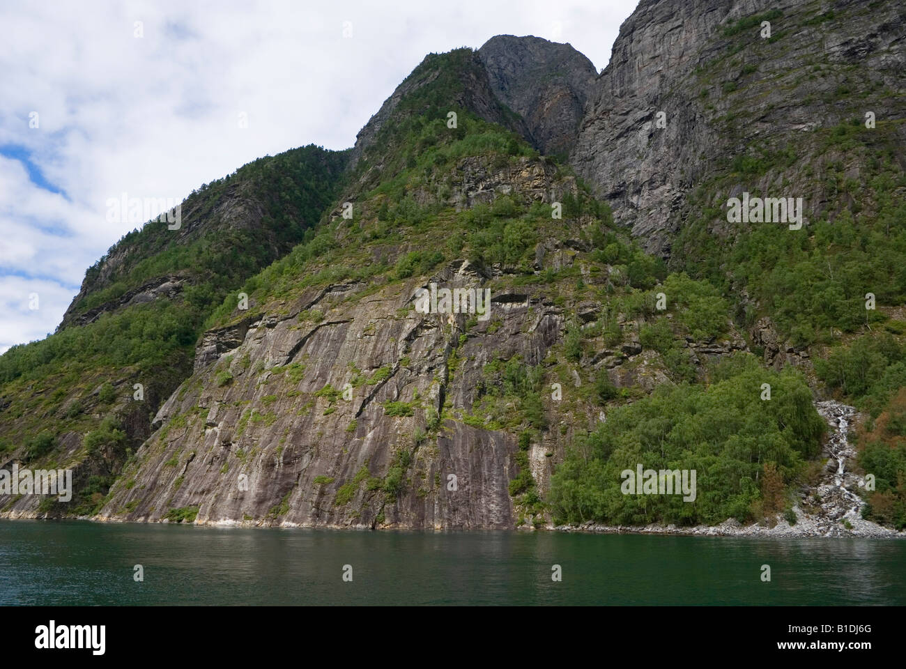 Rocks at the shore of Geiranger fjord Stock Photo - Alamy