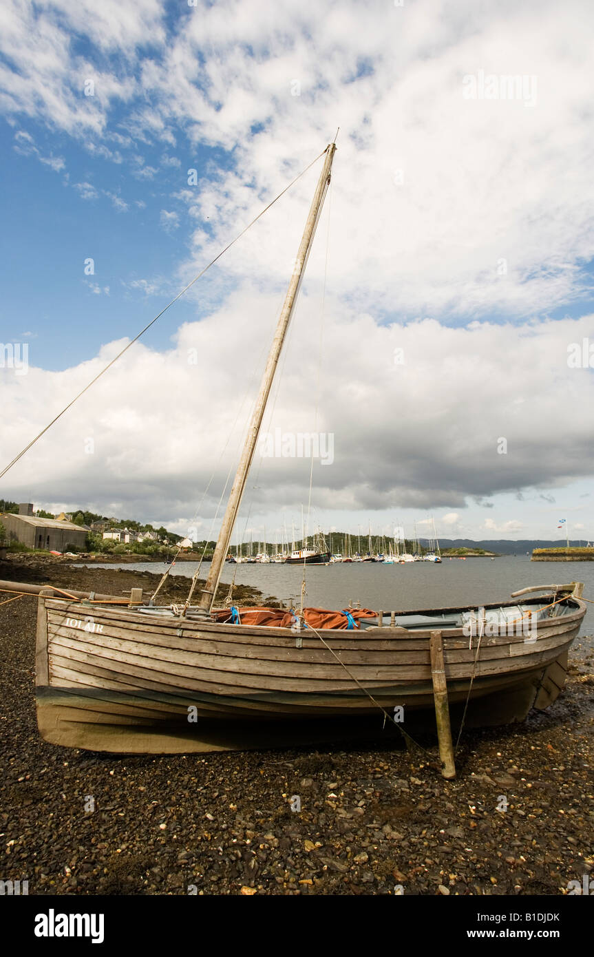 A wooden boat at low tide in Tarbert, Loch Fyne, Scotland an idyllic ...