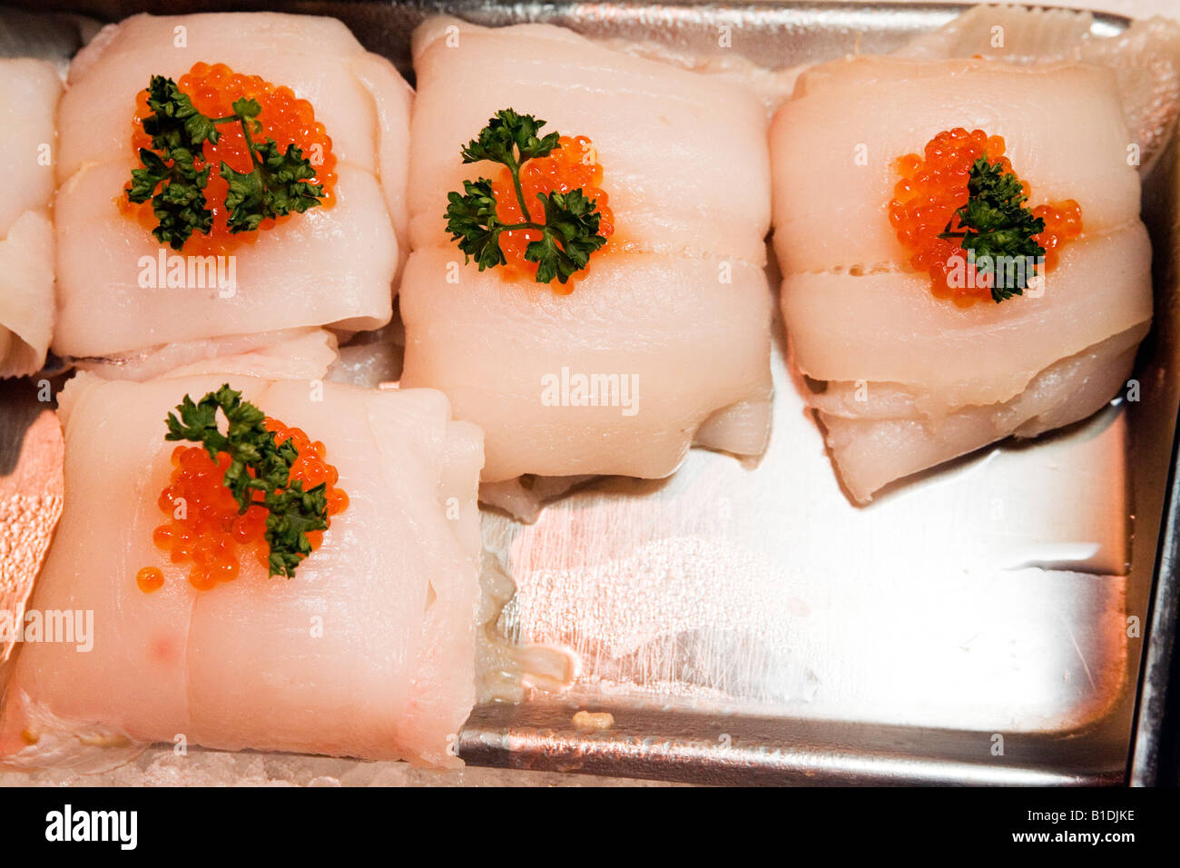 Fresh raw and staffed codfish fillets garnished with fish roe and ...