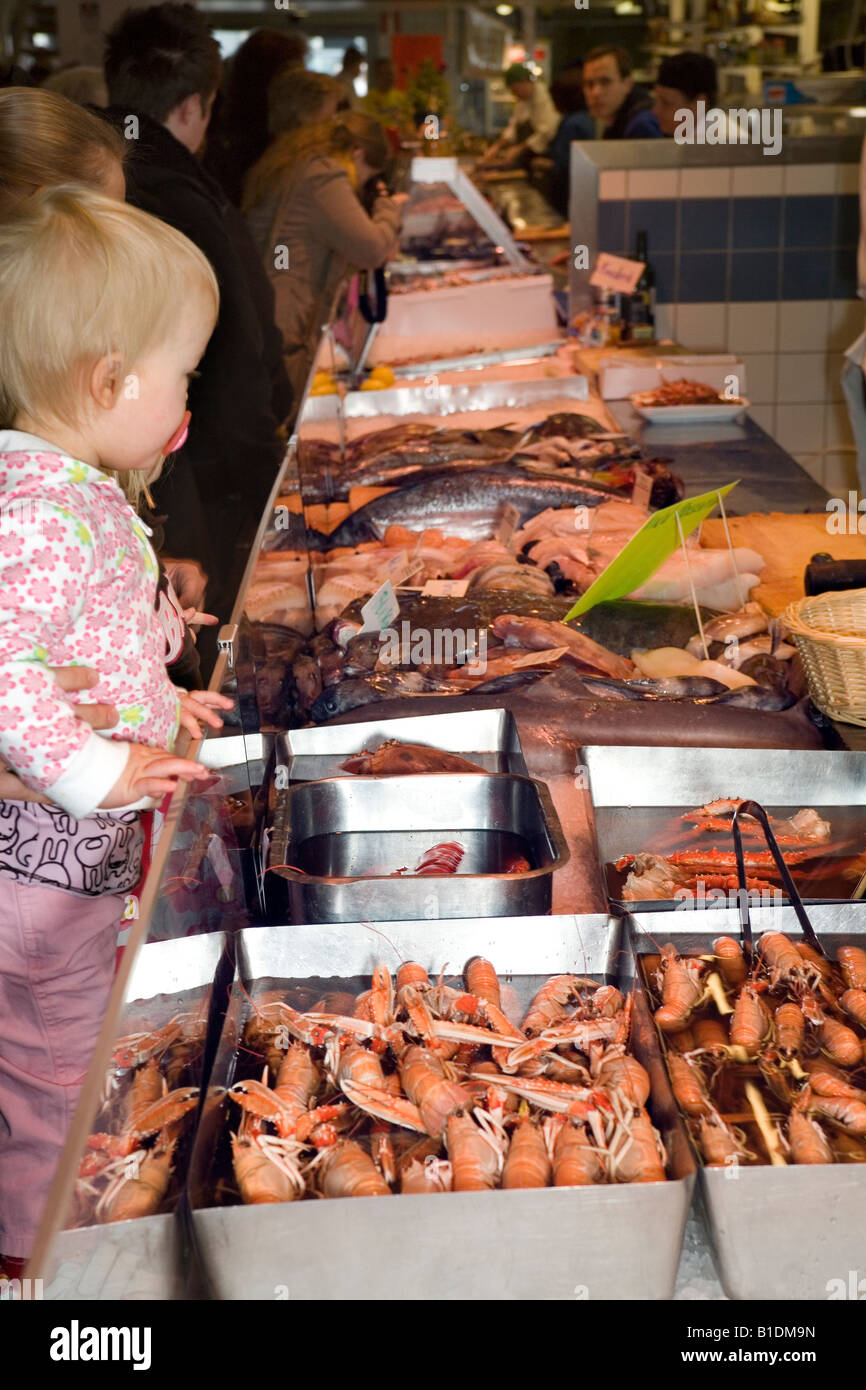 A baby boy watching displayed seafood at famous fish market "Fisekörka ...