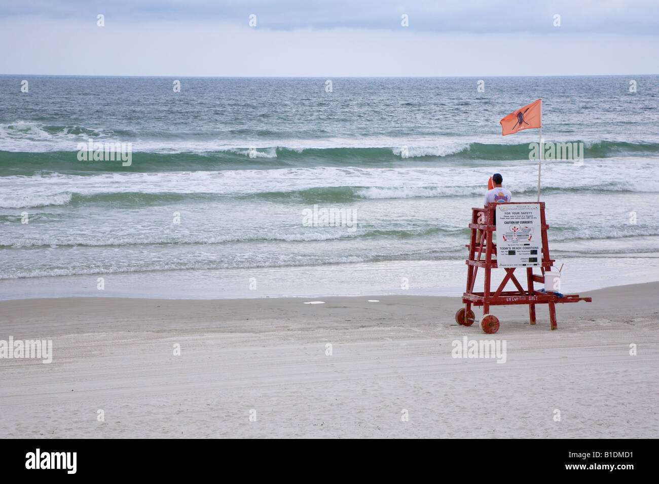 Lifeguard on duty sitting on lifeguard stand at Atlantic Ocean beach in ...