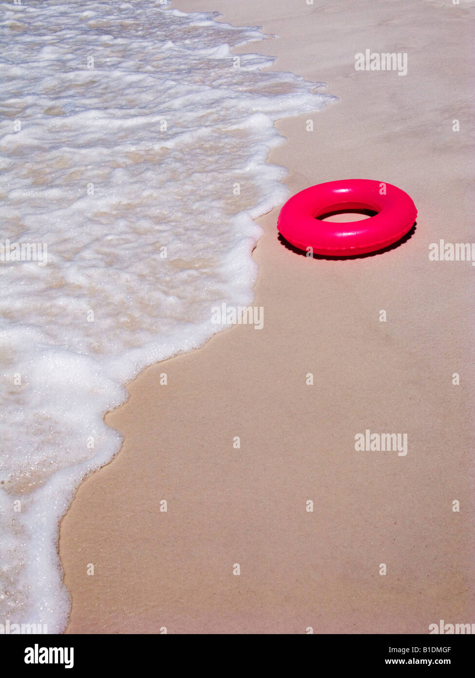 Inflatable ring on beach Stock Photo - Alamy