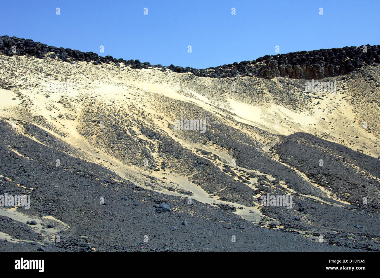 A mountain of volcanic origin in the Black Desert of western Egypt ...