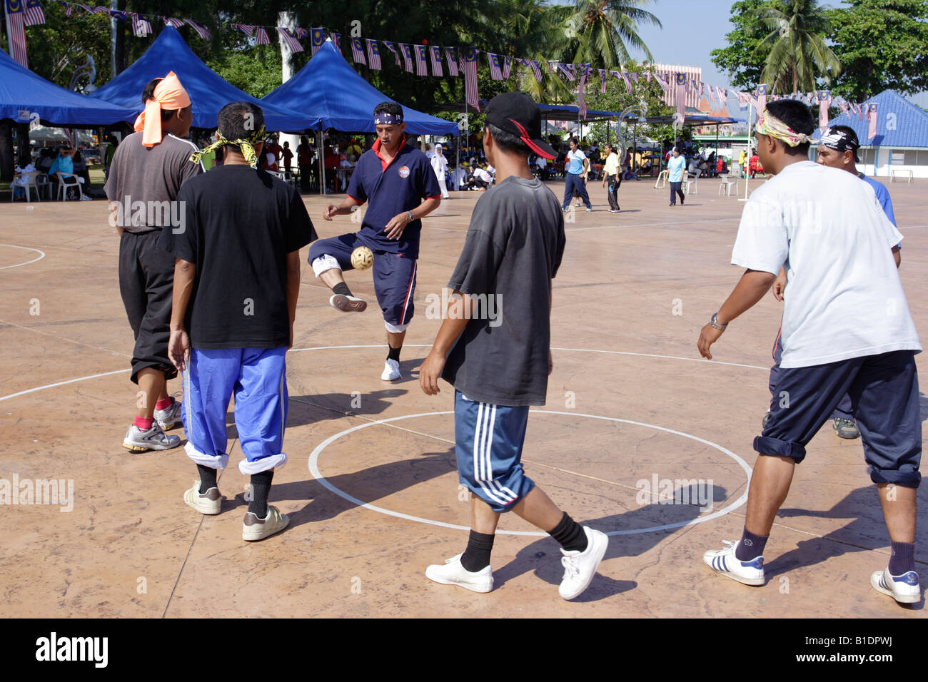 Playing traditional Malay game of Sepak Raga Stock Photo - Alamy