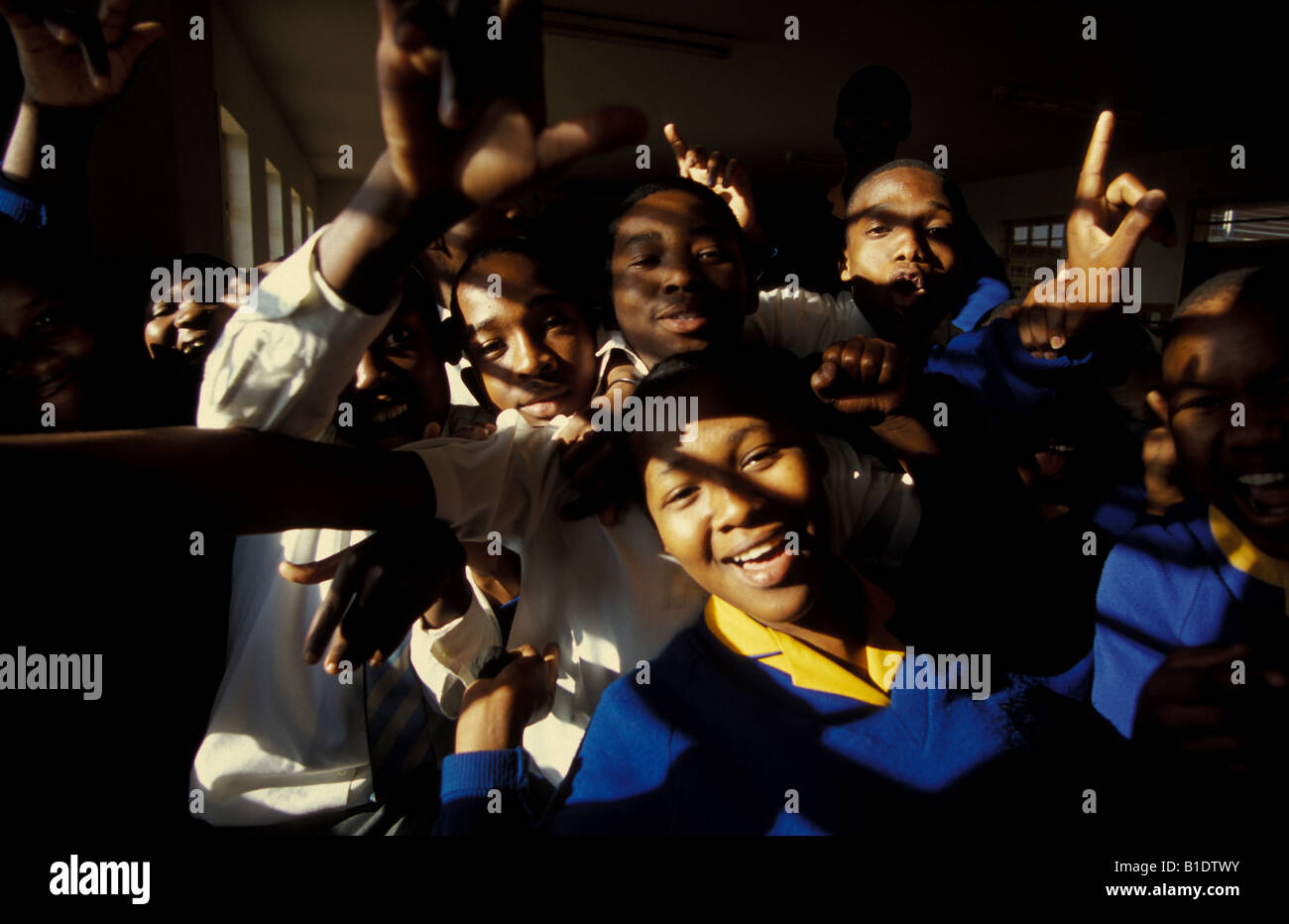 School kids in African township crowding round celebrating Stock Photo ...