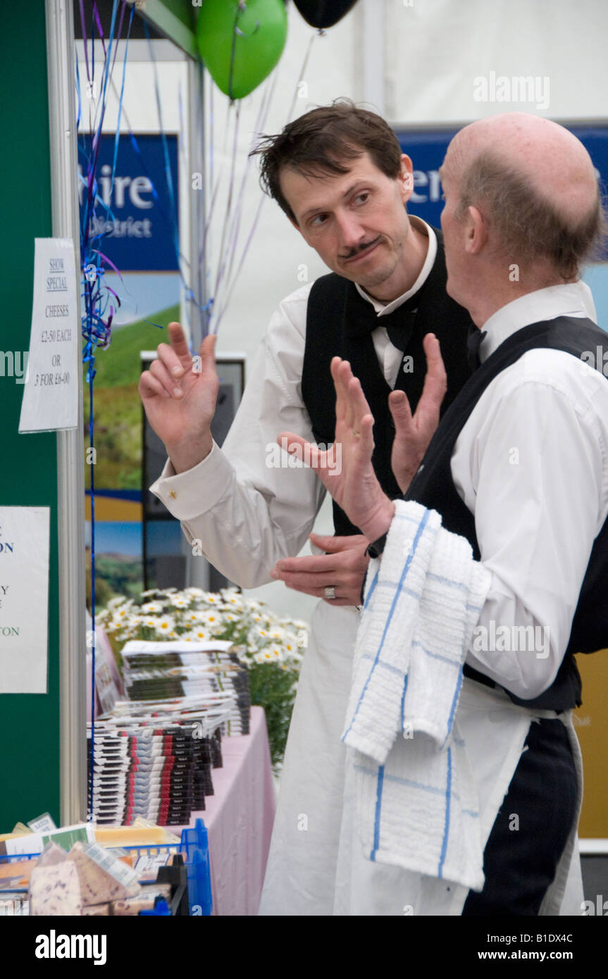 Two men dressed as waiters at a food and drinks fair Derbyshire England ...