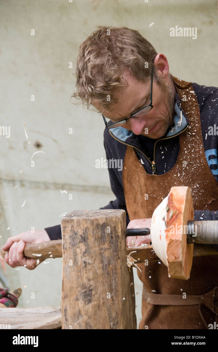 Man demonstrating traditional wood carving on lathe Derbyshire England ...