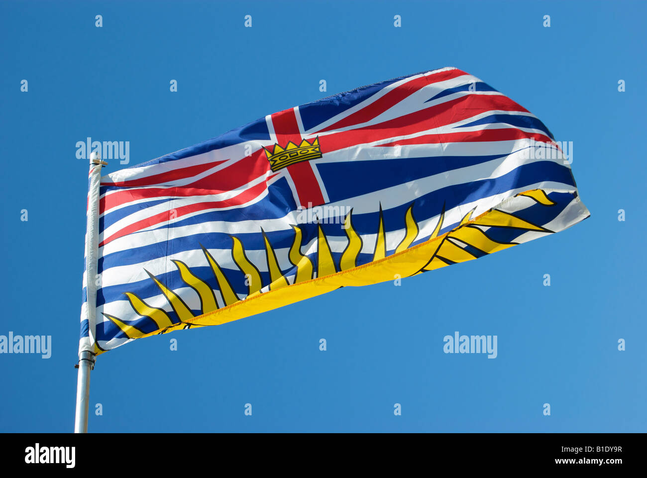Provincial flag of British Columbia against a brilliant blue sky Stock ...