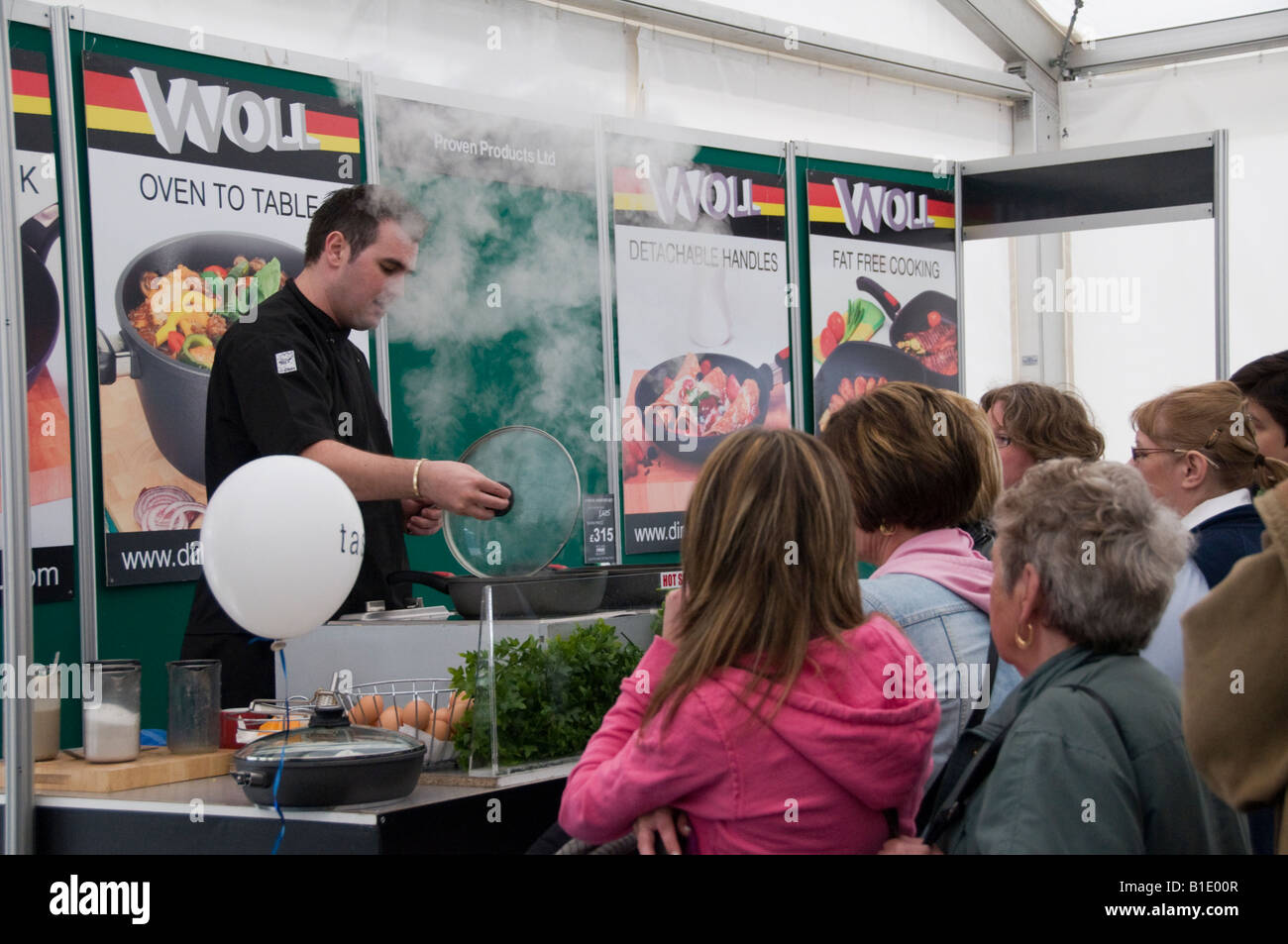 Man demonstrating at a cookery stall Stock Photo - Alamy