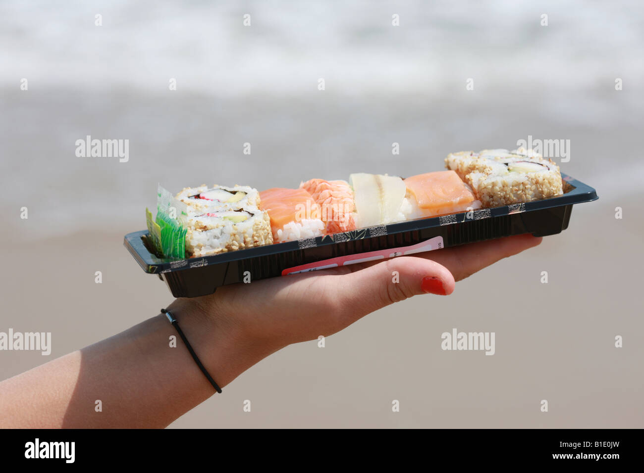 Young Woman Holding Sushi Model Released Stock Photo - Alamy