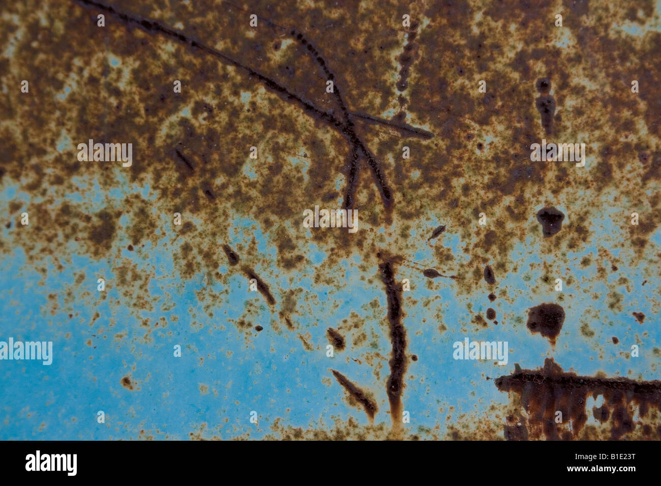 Scratch marks on blue metallic background with rust from age showing ...