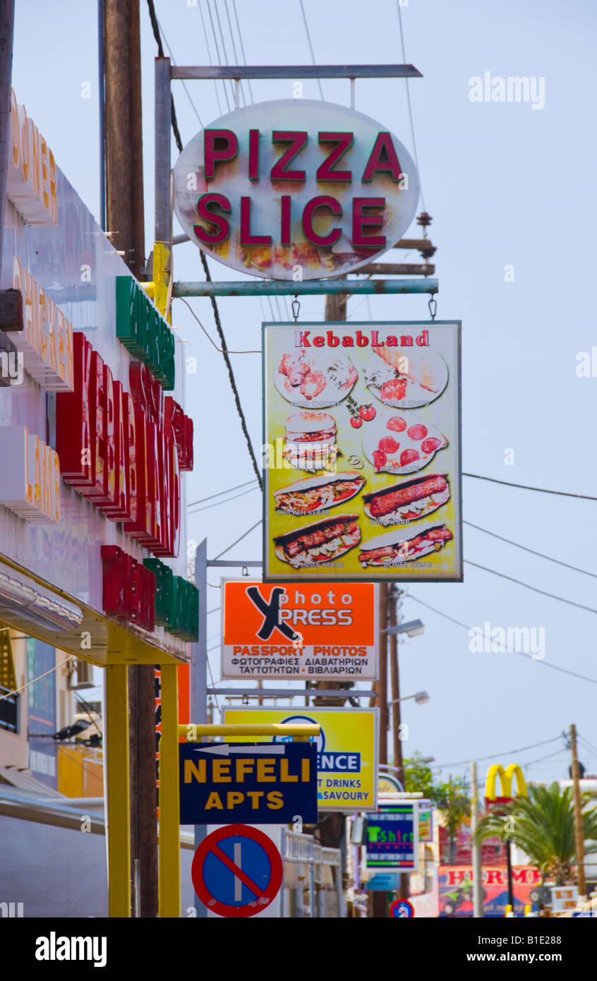 Advertising signs for shops in Malia on the Greek Mediterranean island ...