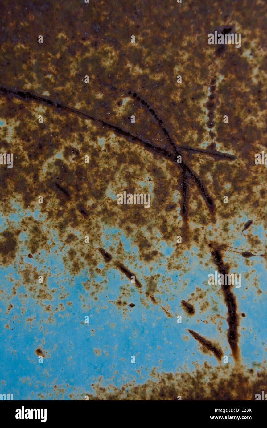 Scratch marks on blue metallic background with rust from age showing ...
