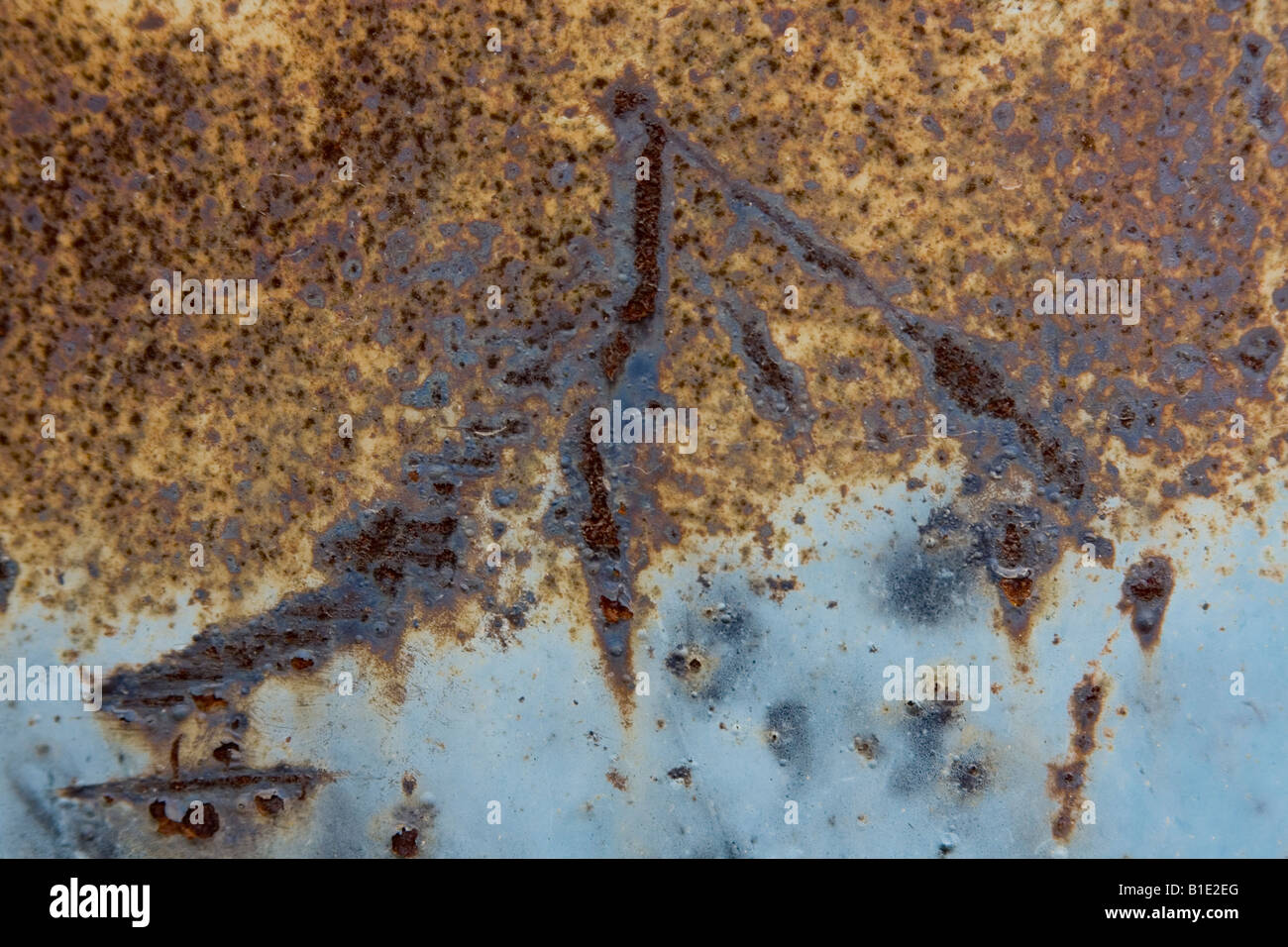 Scratch marks on blue metallic background with rust from age showing ...