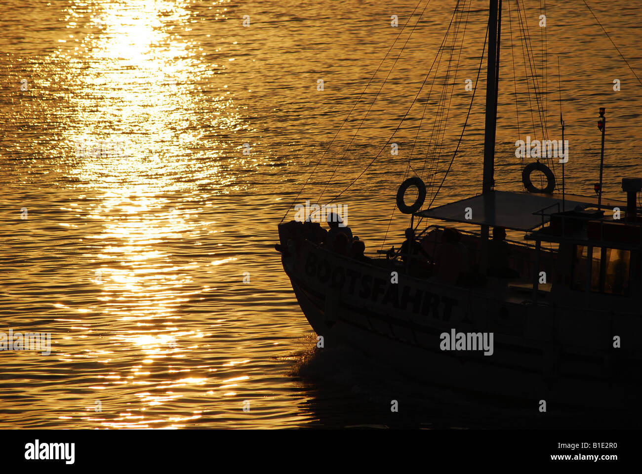 A small boat in the sunset Stock Photo - Alamy