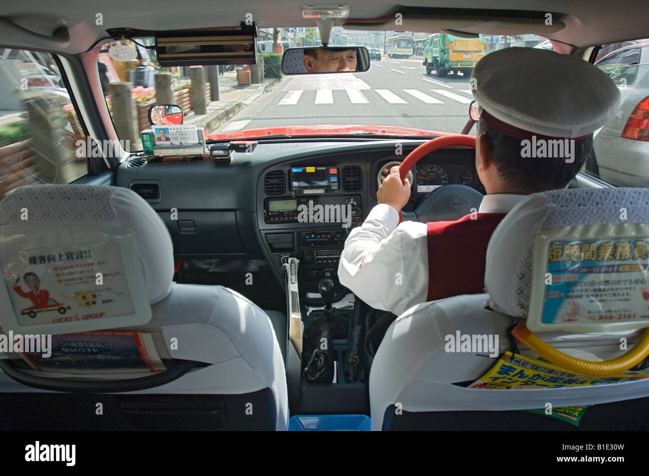 View from the backseat of a Japanese Taxi with the driver wearing ...