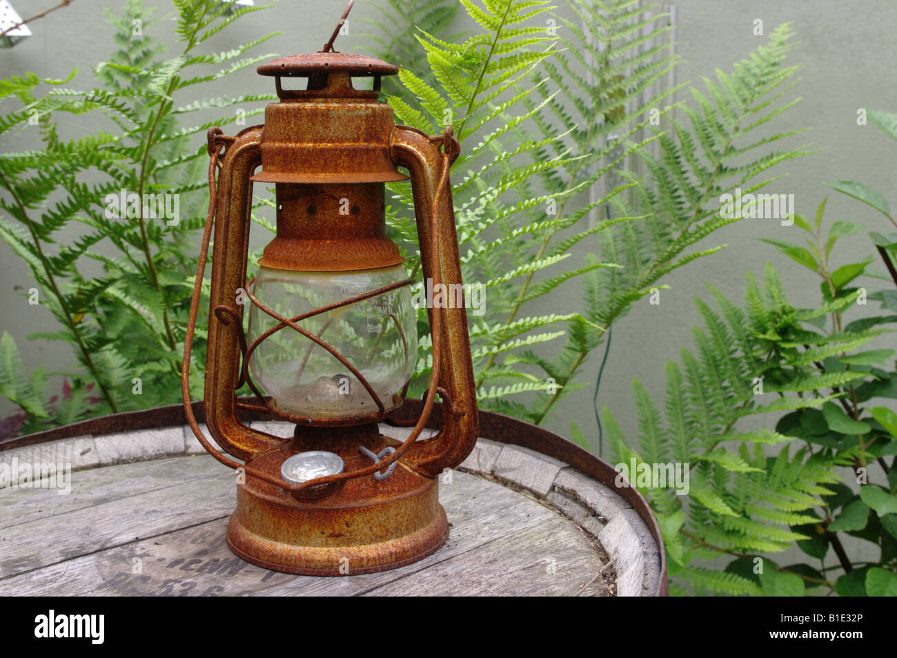 Rusty old lantern on a barrel Stock Photo - Alamy