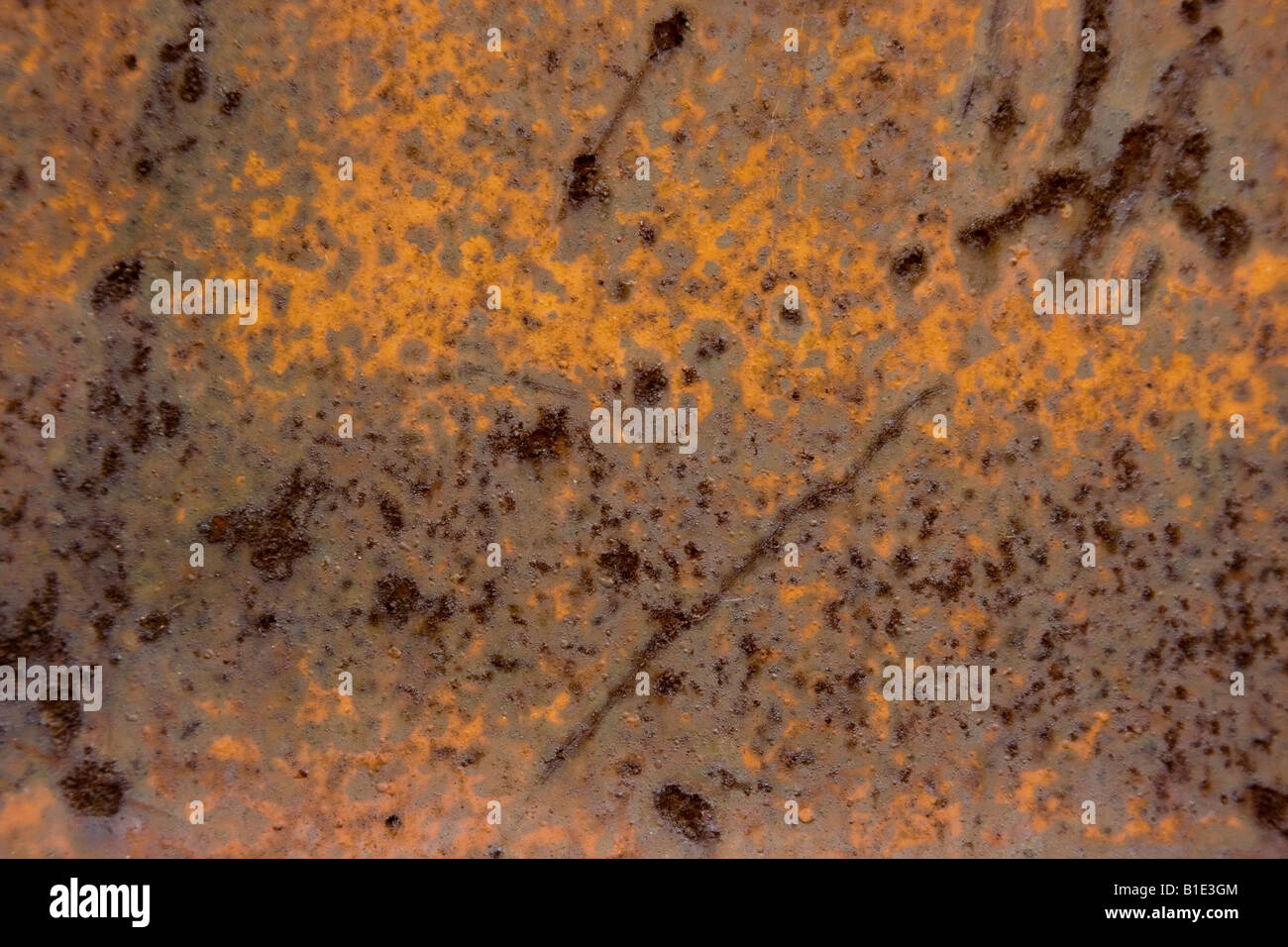 Scratch marks on golden orange metallic background with dark rust from ...