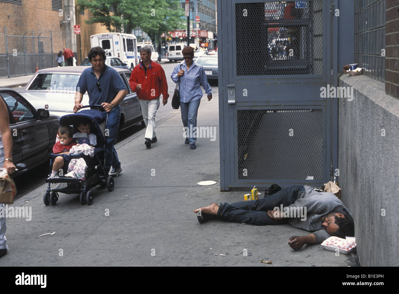 Very sick looking homeless man passed out on the sidewalk along Park ...