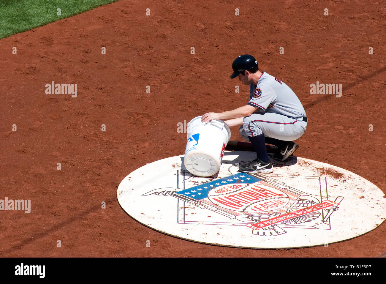 A ball boy prepares the on deck circle for the visiting Washington ...