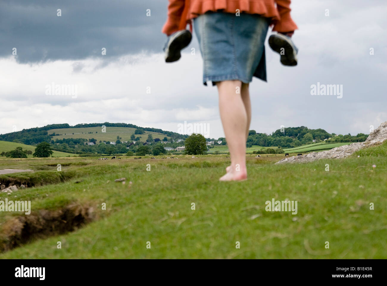 Woman walking barefoot grass legs hi-res stock photography and images ...
