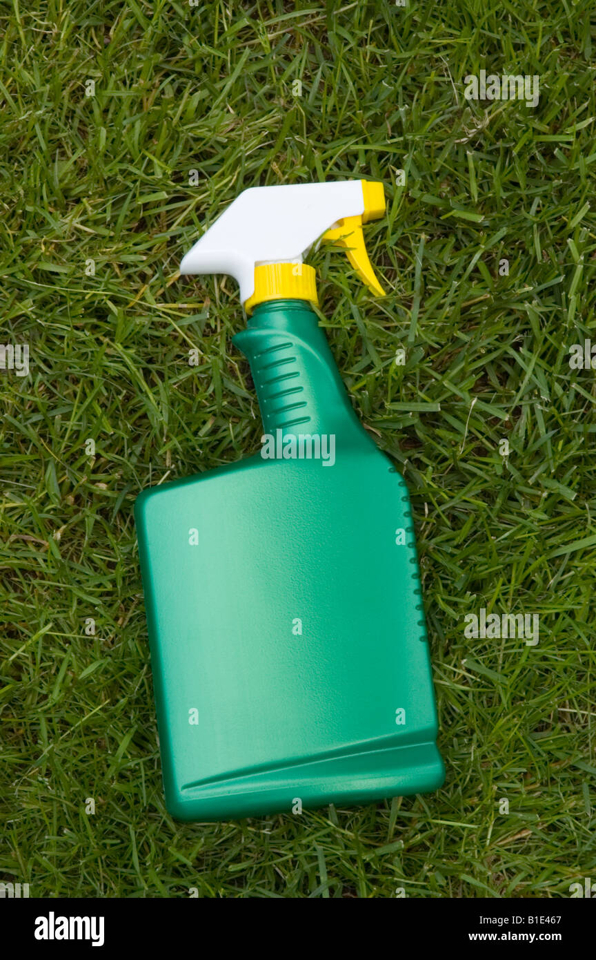 Spray bottle of herbicide for weed control on nice green lawn Stock ...
