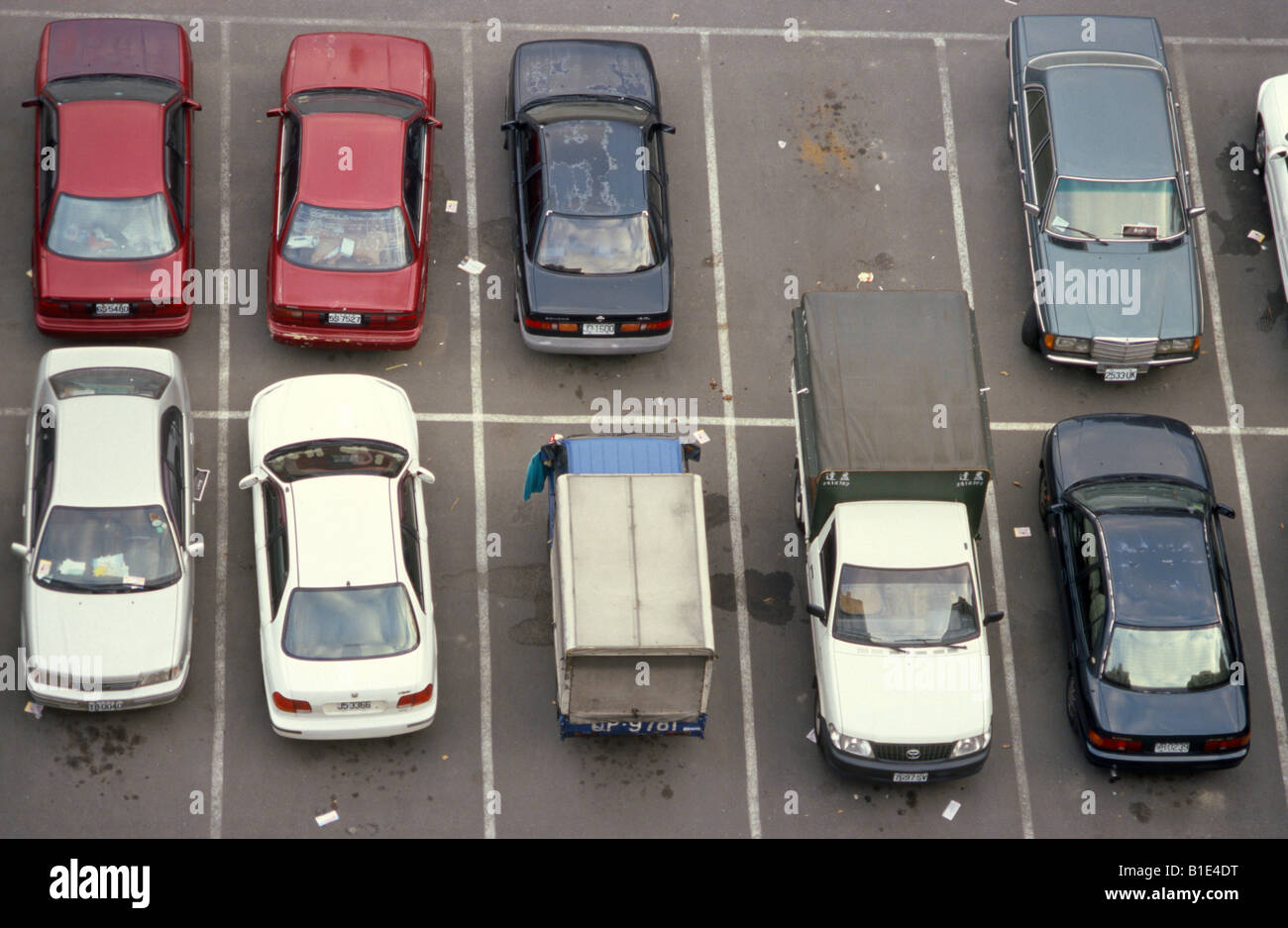 A parking lot with one space left and fliers laying on the ground Stock ...