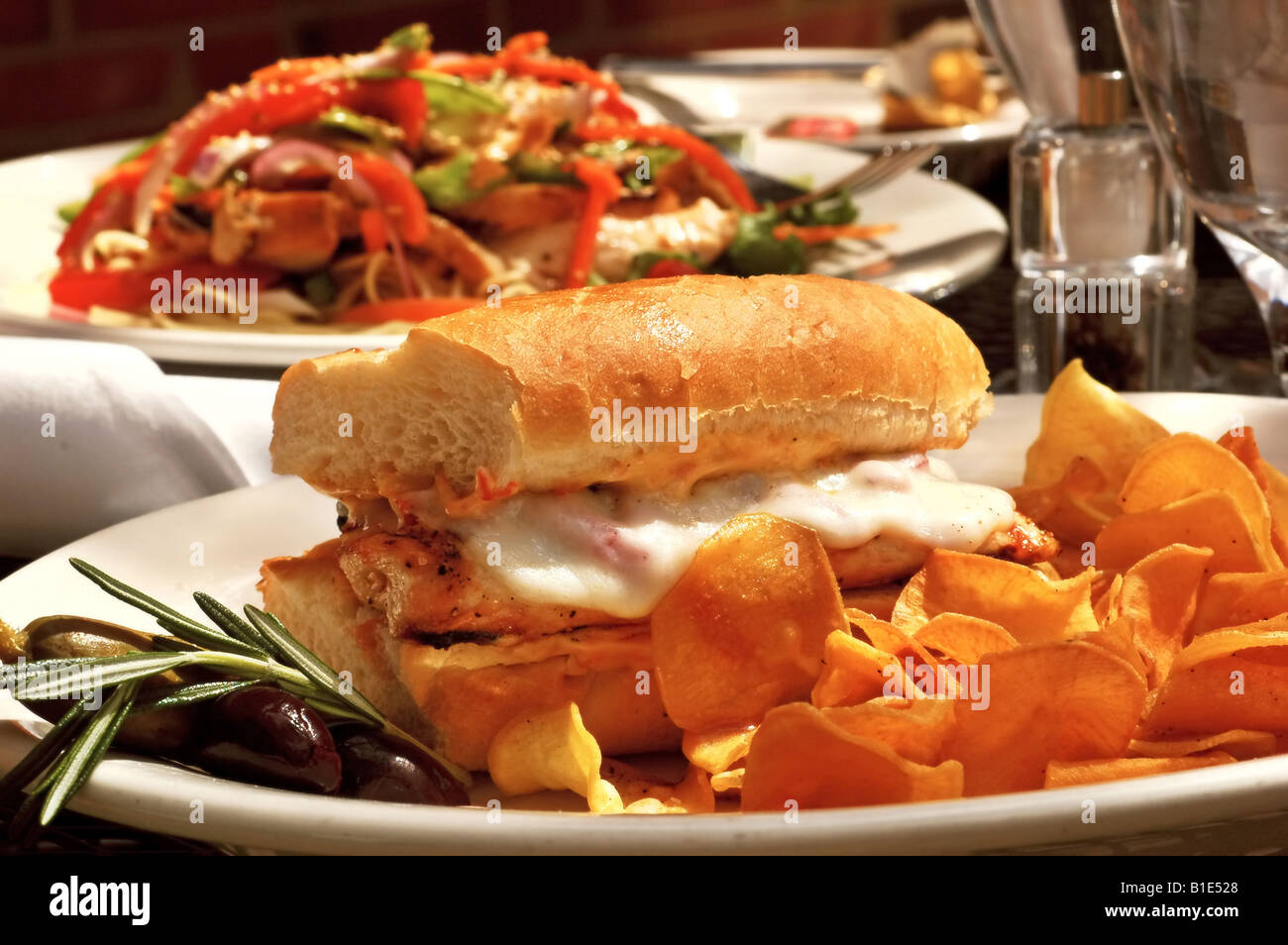 Grilled chicken sandwich with melted provolone and sweet potato chips ...