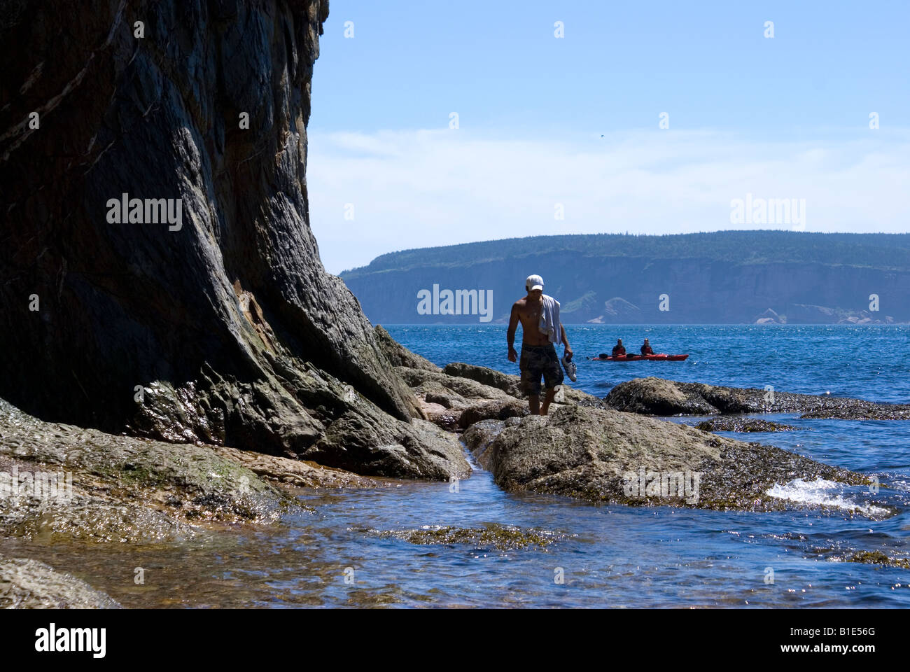 Perce rock walkers low tide Quebec Canada Stock Photo - Alamy