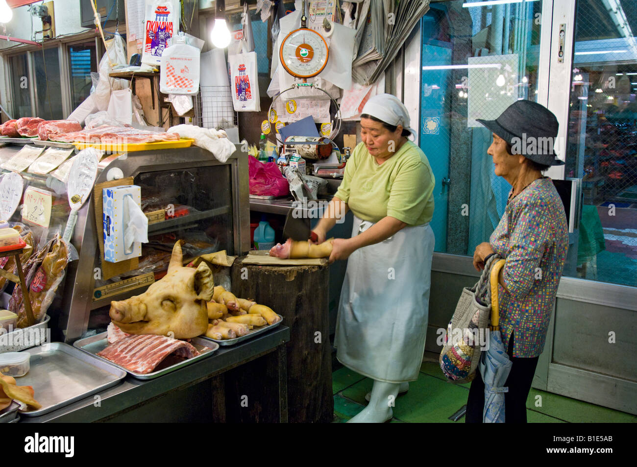 Market Trader specializing in Okinawa Pork, chopping pigs trotters for ...