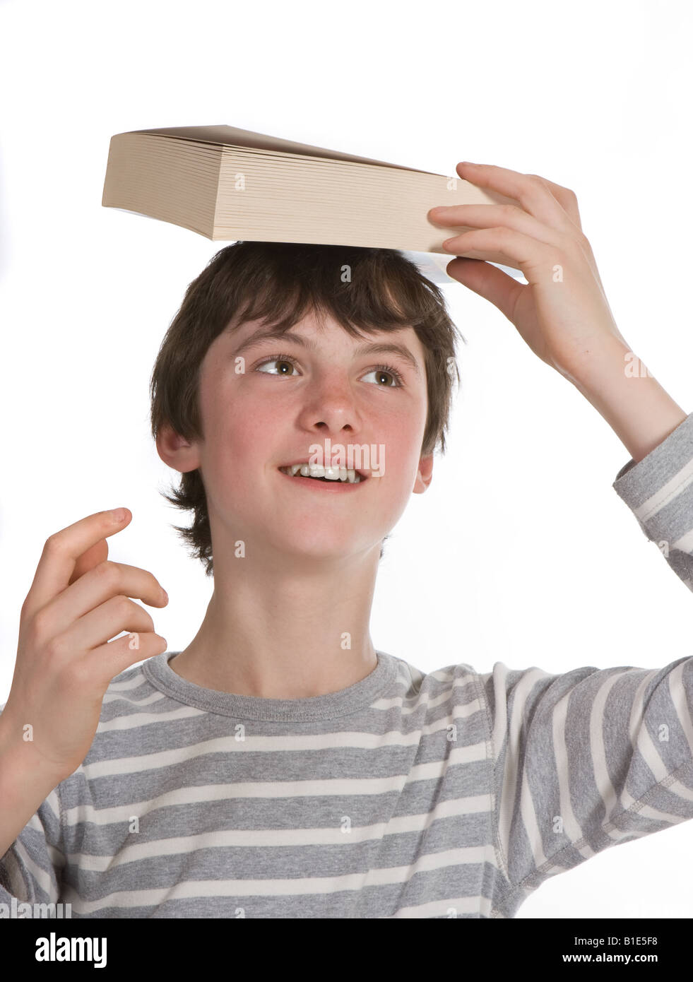 Young teenager boy balancing a book on his head Stock Photo - Alamy