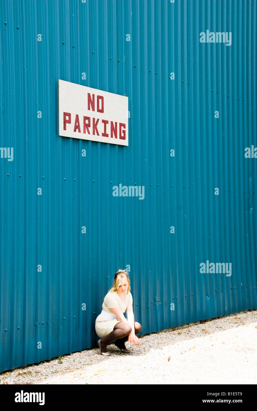 blonde female teenager waiting under no parking sign Stock Photo - Alamy