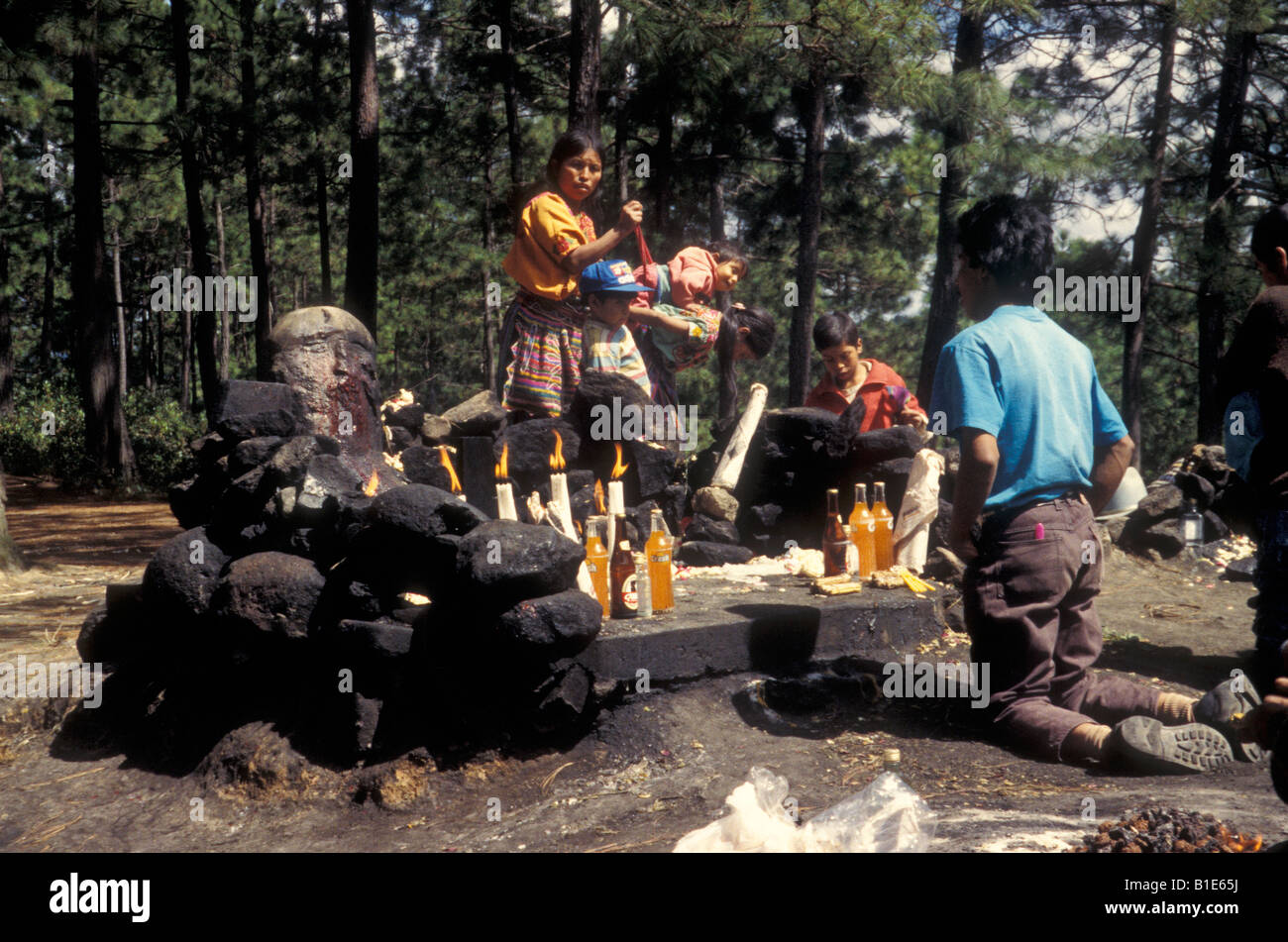 Maya man making offerings in front of tha altar at the Shrine of ...