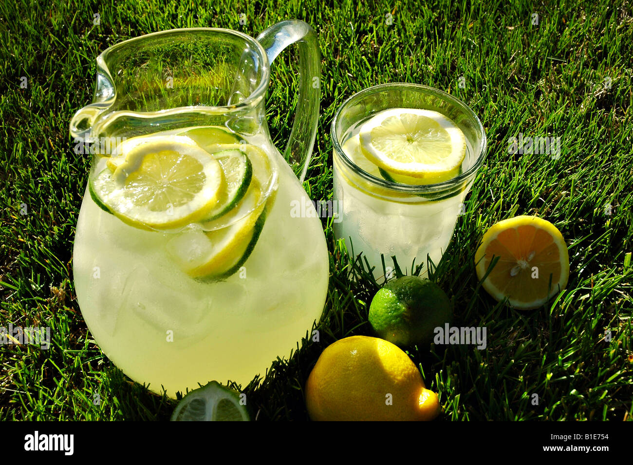 Pitcher and glass of iced lemonade lit by the late afternoon sun Stock ...