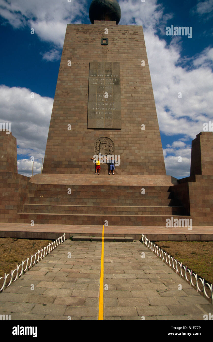 People posing on equator monument Ecuador Stock Photo - Alamy