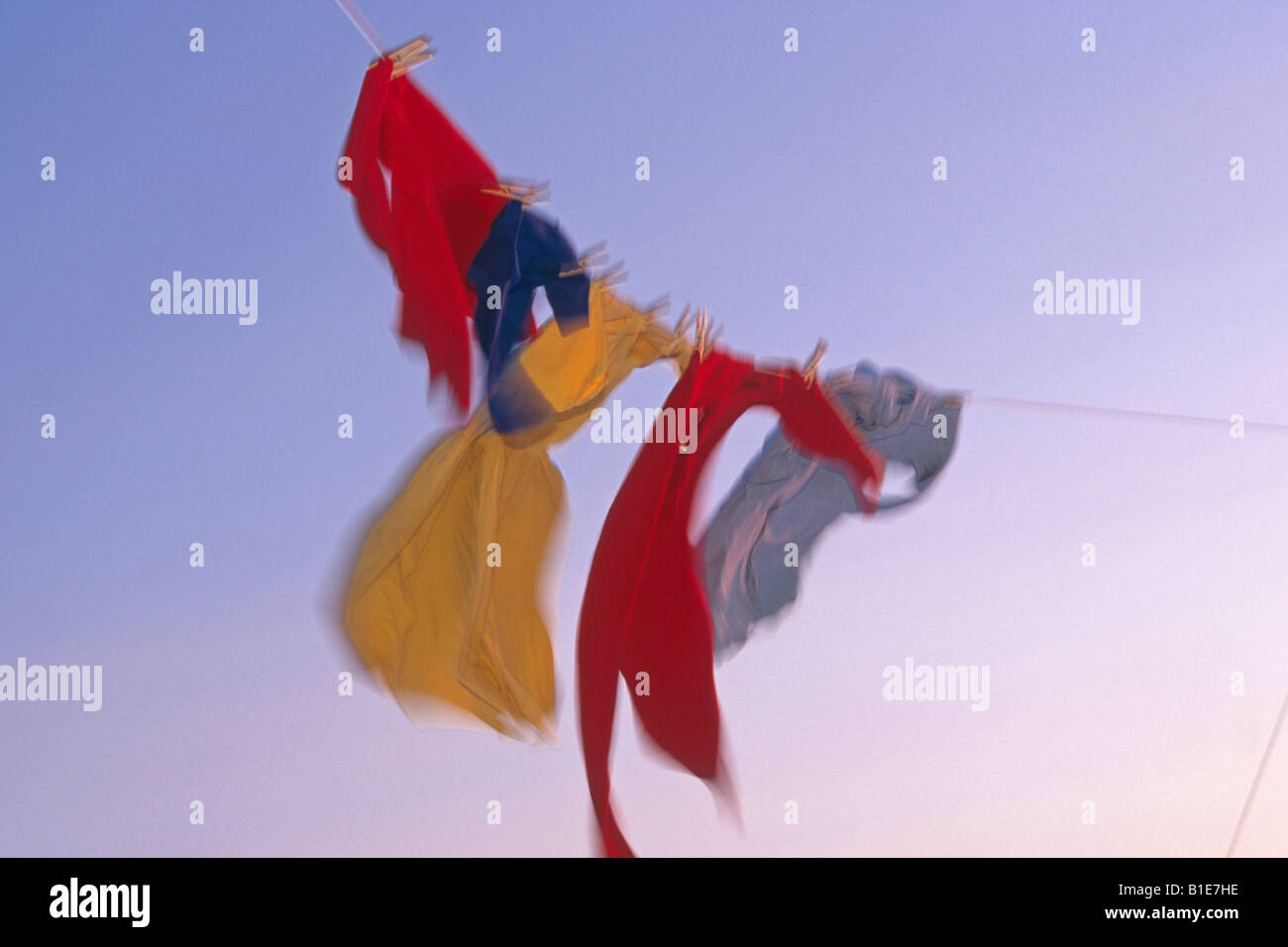 US Flag & Clothing on clothes line blowing in the wind against blue sky ...