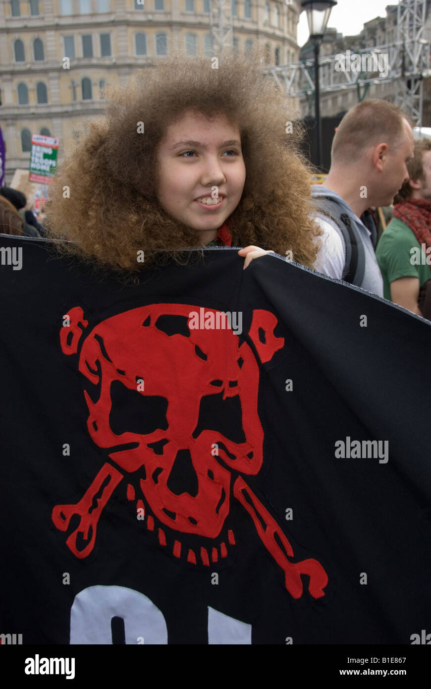 Young anarchist holds black banner with red skull and crossbones ...