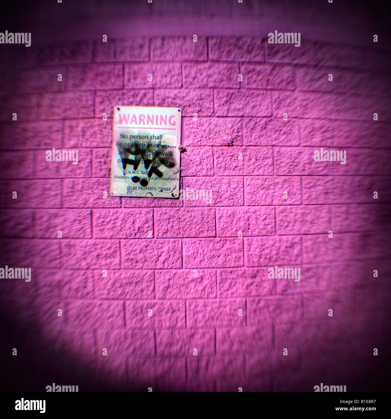 Warning Sign on a purple wall Stock Photo - Alamy