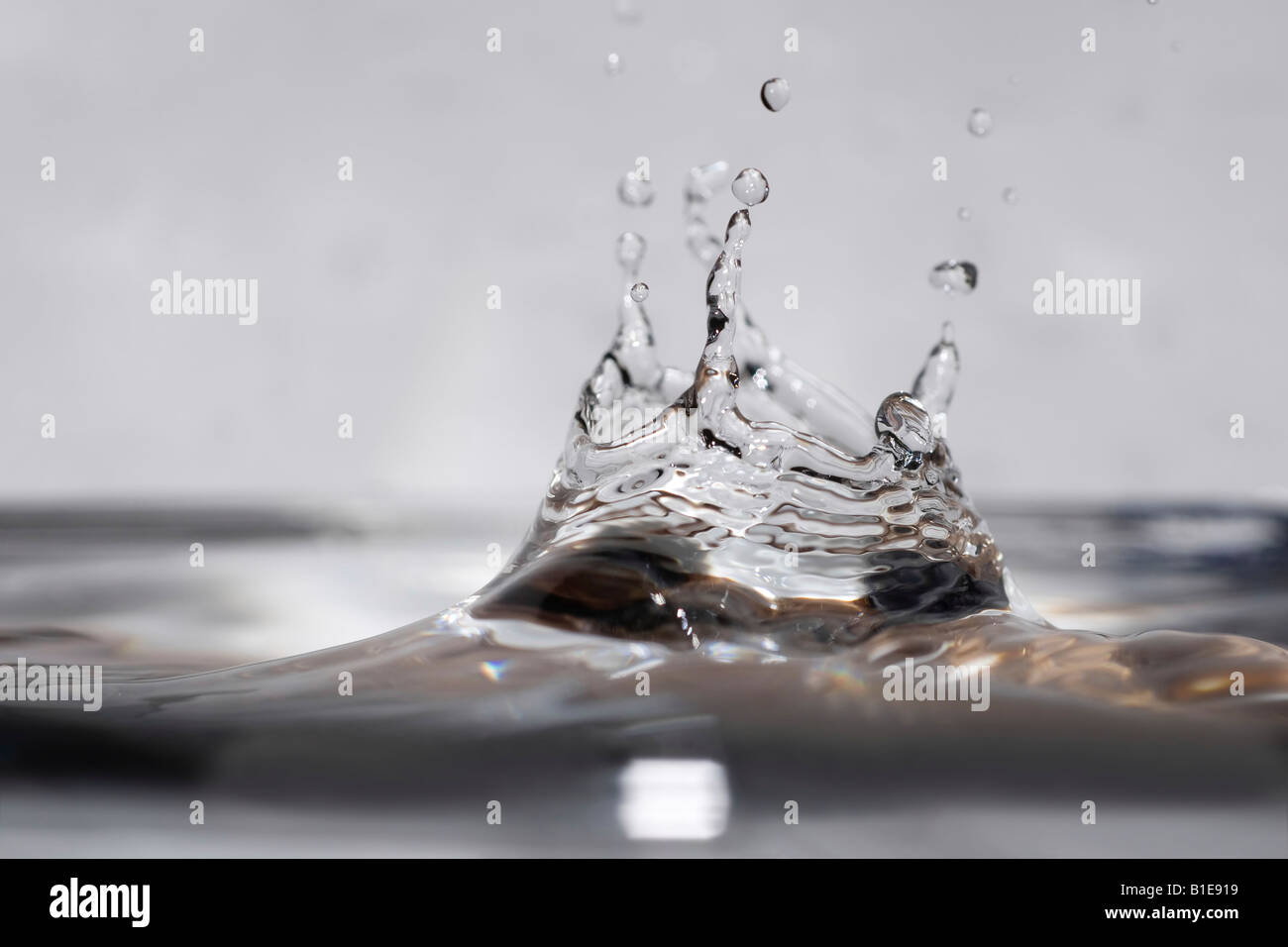 Water droplet hitting the water and creating a splash Stock Photo - Alamy