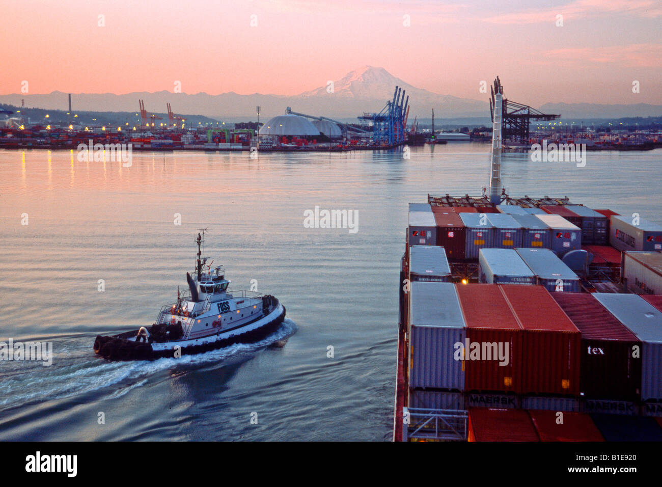 Puget Sound, Tacoma, Washington, USA. Tug escorting container ship ...