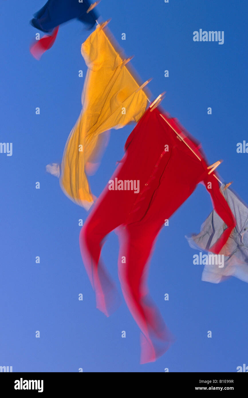 US Flag & Clothing on clothes line blowing in the wind against blue sky ...