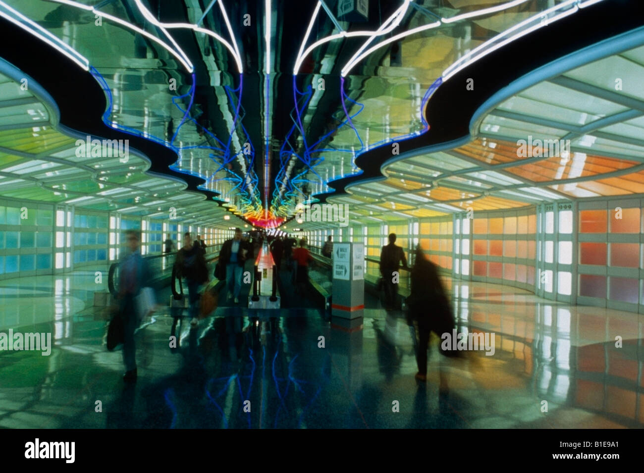Distorted & Blurred people on moving walkway in glass hallway Ohare ...