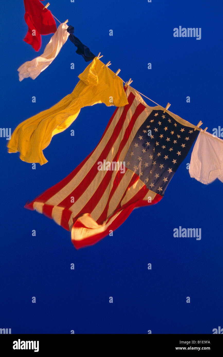 US Flag & Clothing on clothes line blowing in the wind against blue sky ...
