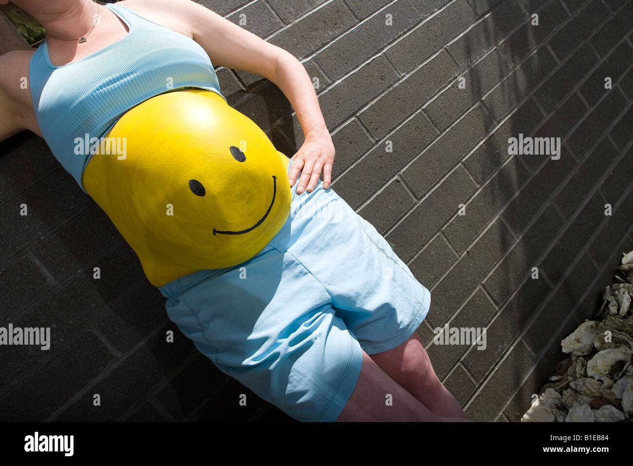 Pregnant woman with yellow Smiley Face painted on her stomach Alaska ...