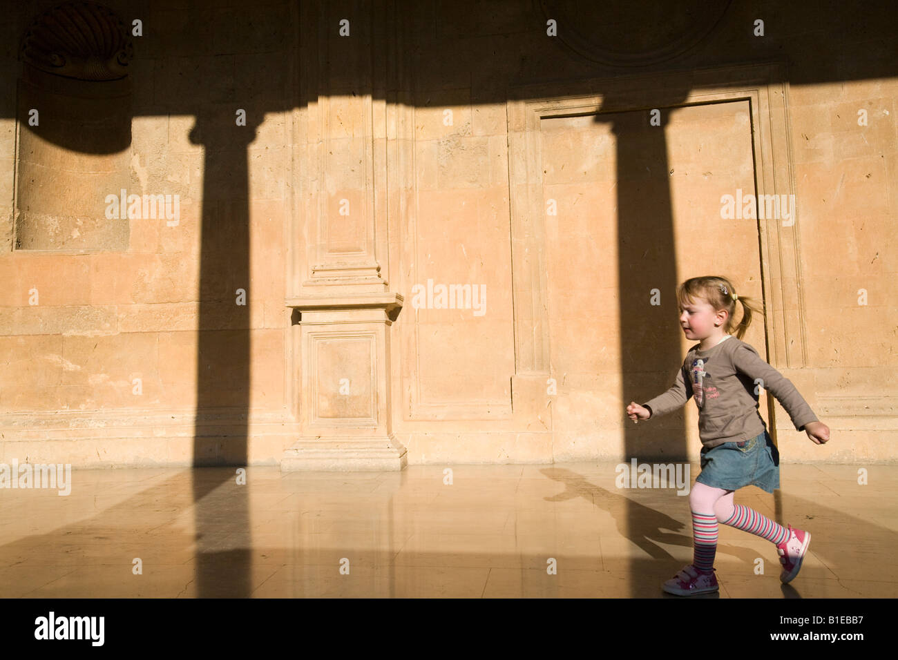 Little girl running on the upper gallery of the Palace of Charles V ...