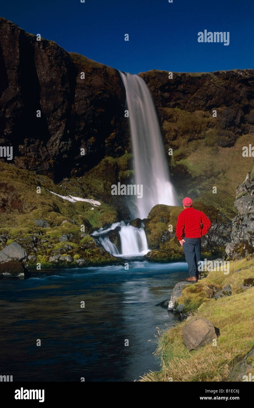 Man standing and watching Picturesque waterfall Iceland Stock Photo - Alamy