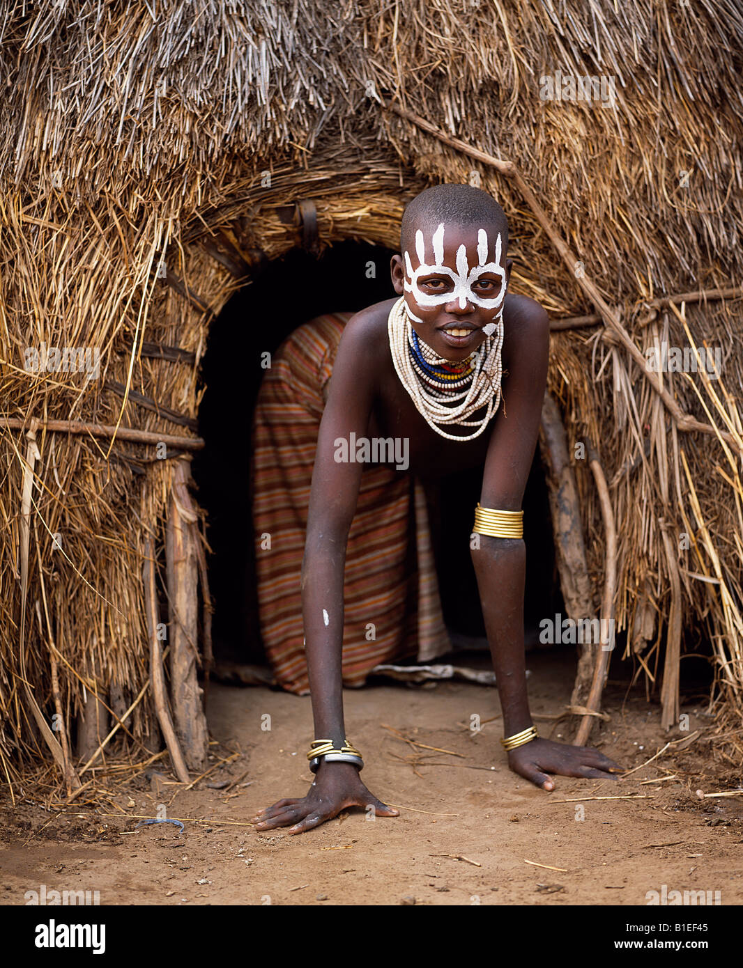 A young Karo girl in the doorway of her hut in the village of Duss. A ...