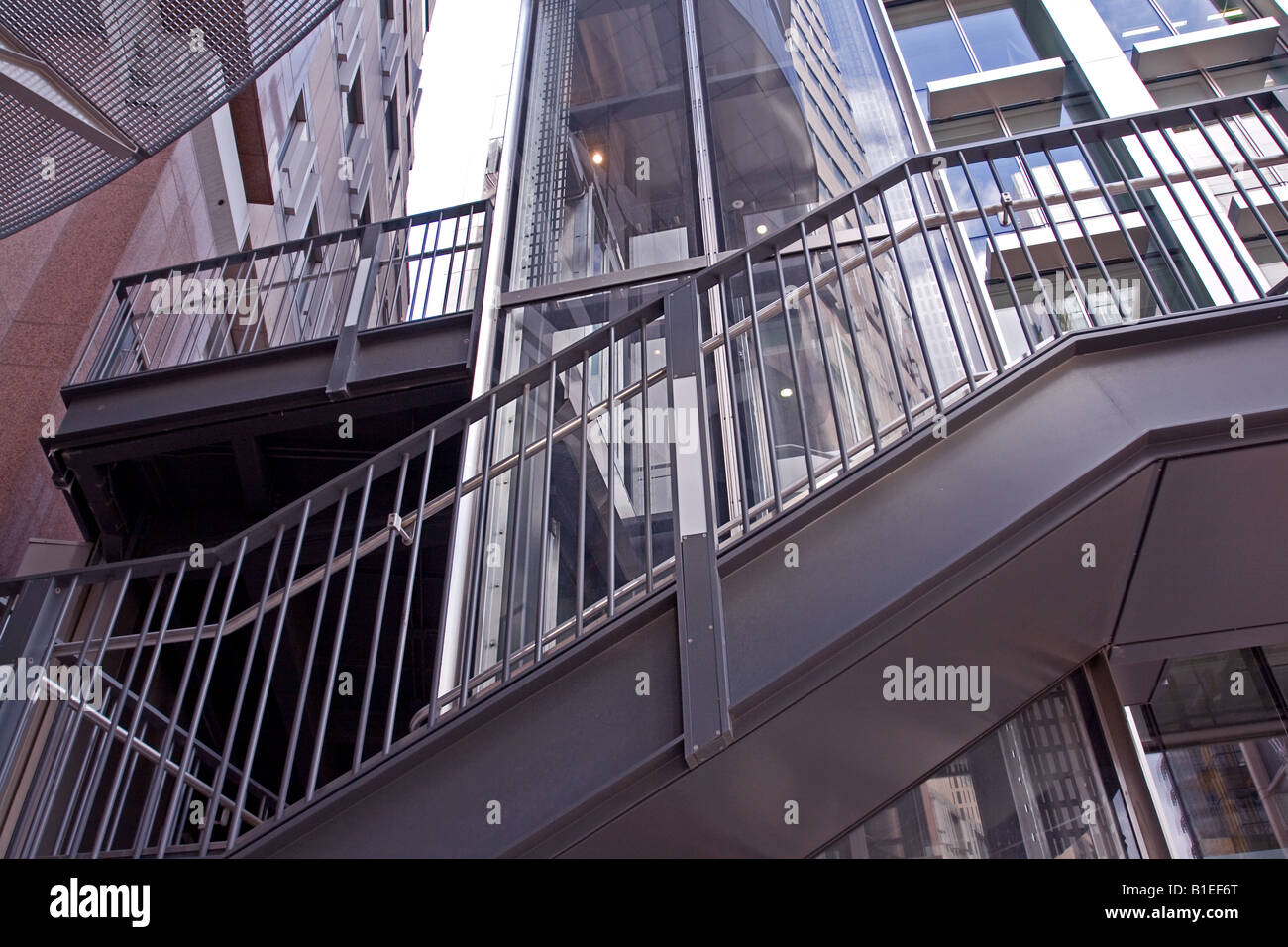 Looking up at office building with stairs and walkway Stock Photo - Alamy