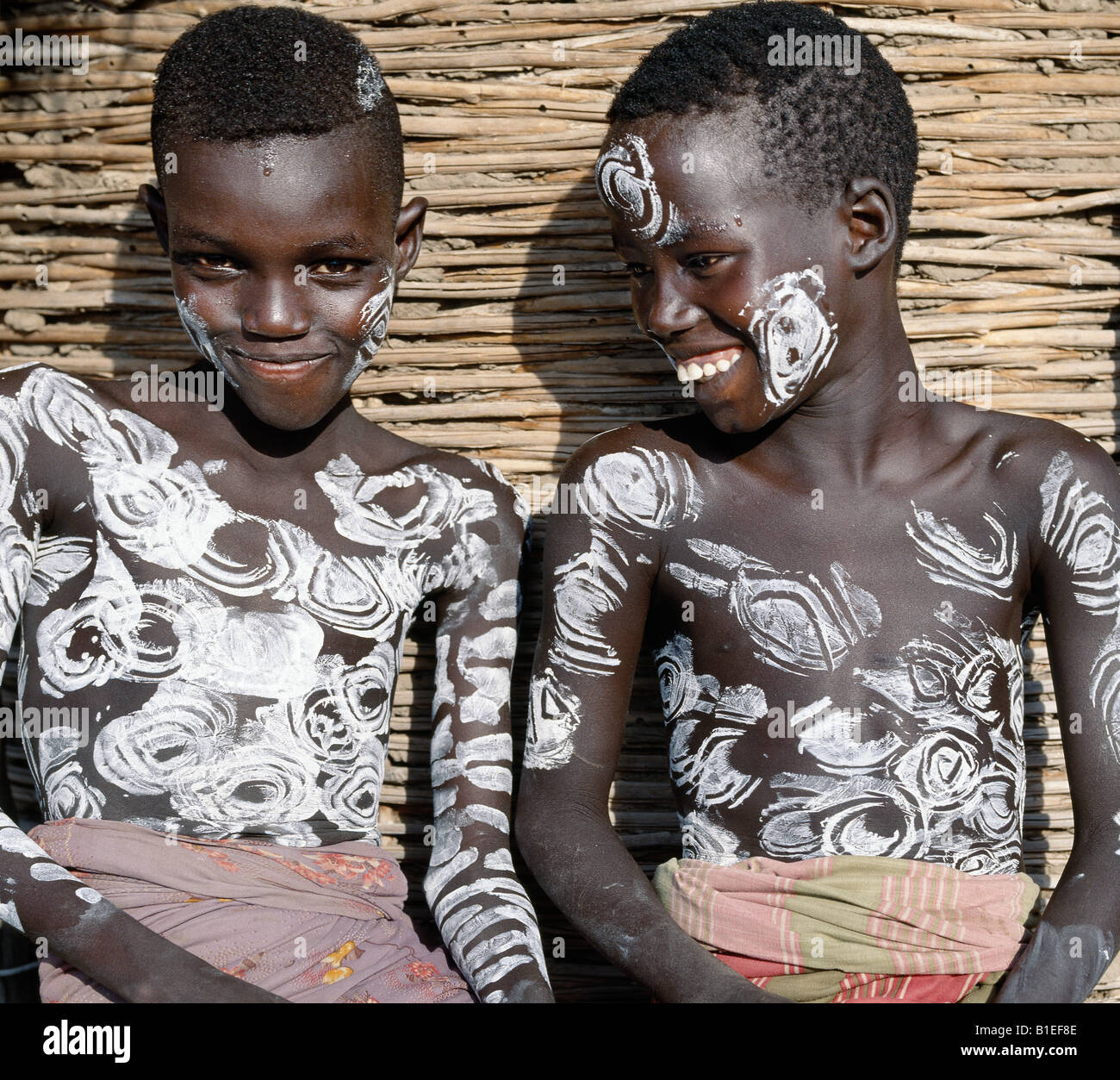 Two young Karo boys with their faces and torsos painted in readiness ...